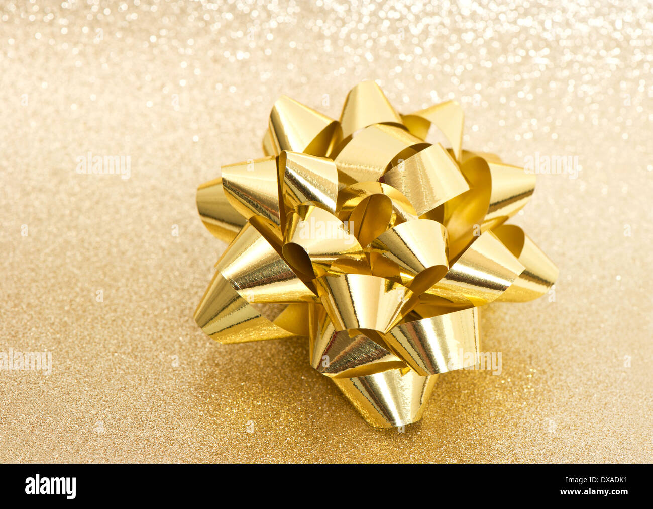 beautiful bow on shiny golden background Stock Photo - Alamy