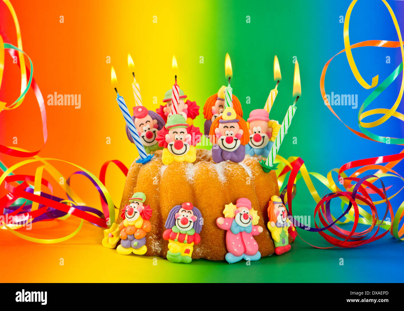 birthday cake with candles and colorful streamer Stock Photo - Alamy