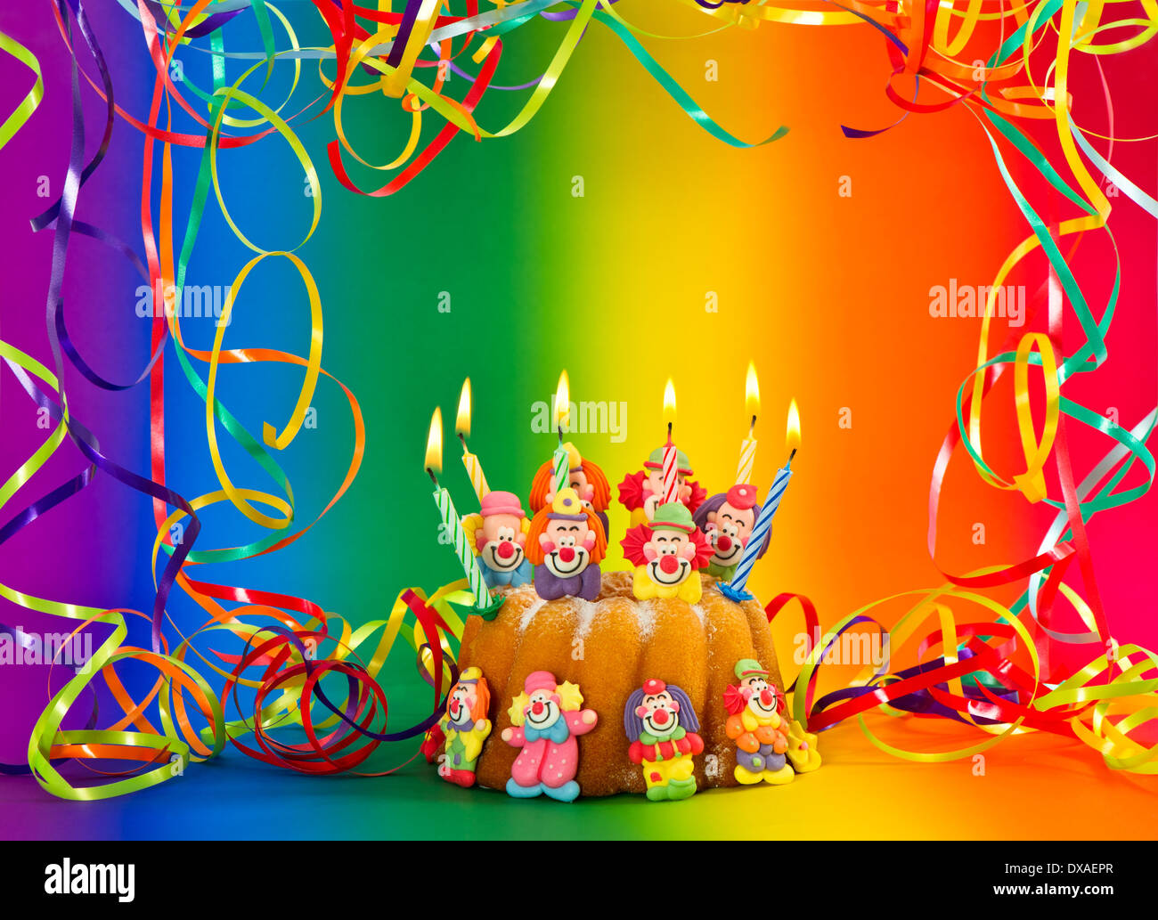 Birthday cake with sugar clowns decoration and candles Stock Photo - Alamy