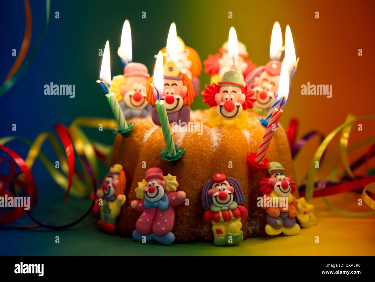 Birthday cake with sugar clown decoration and candles. selective fokus ...