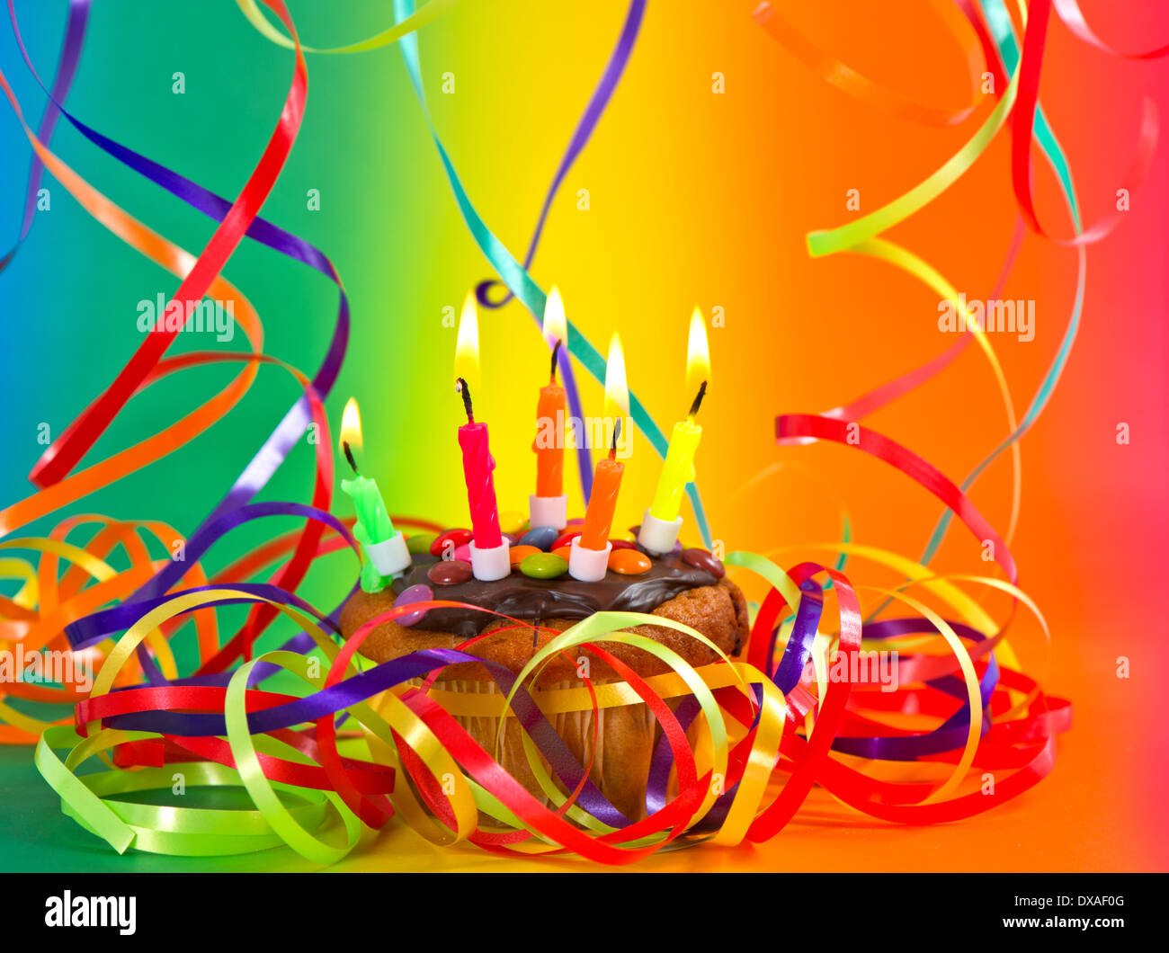birthday cupcake with candles and colorful streamer decoration Stock ...