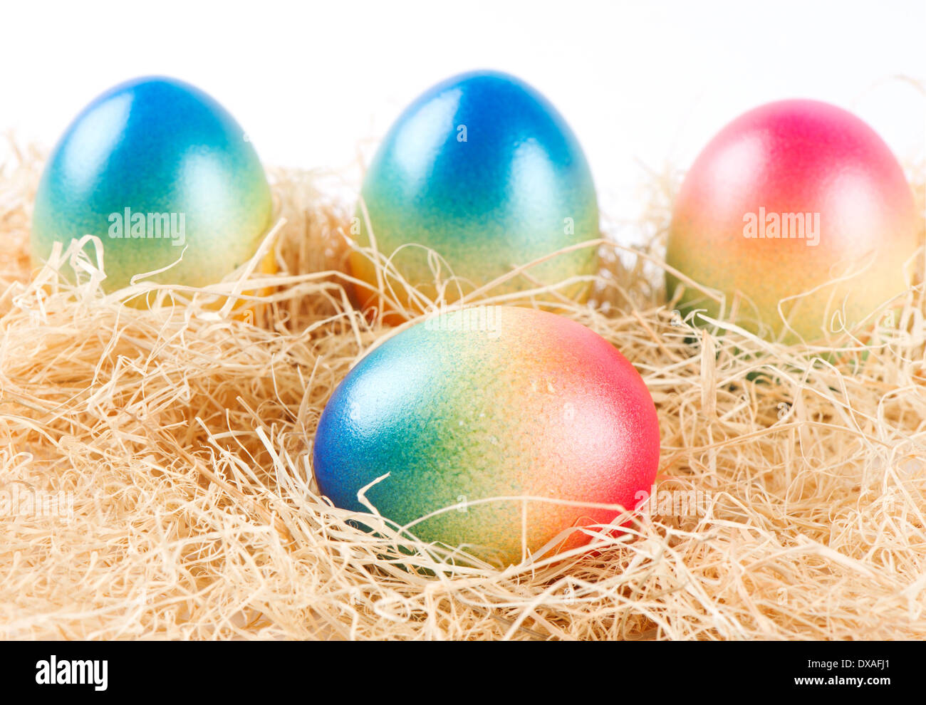 colorful easter eggs lying on some hay Stock Photo - Alamy