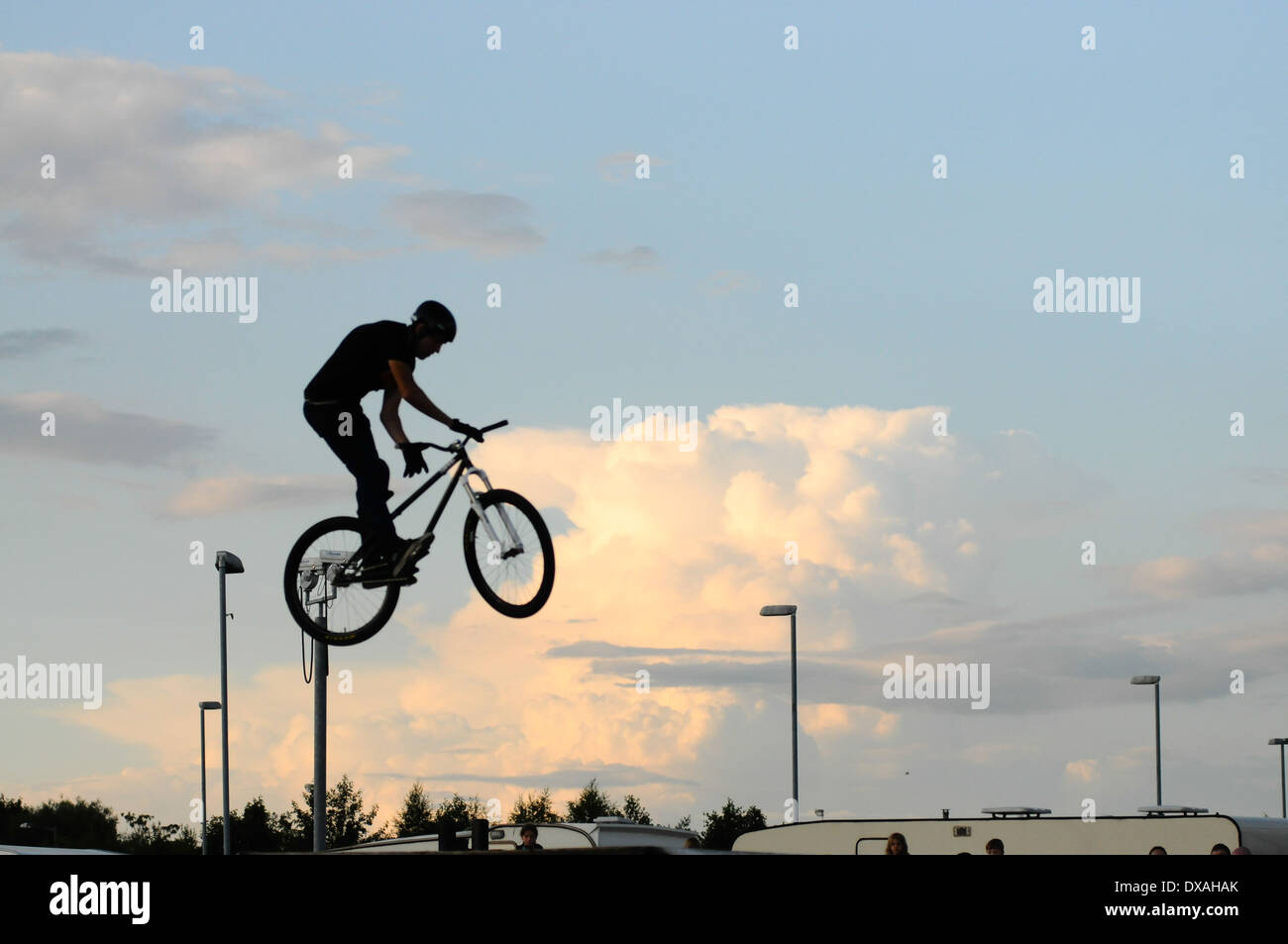 BMX bike rider pulling a stunt while leaping high in the air Stock ...