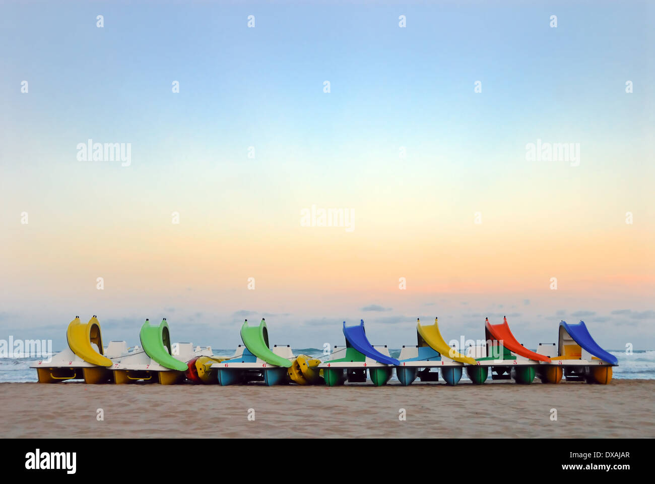 Some color boats aligned in a beach Stock Photo - Alamy