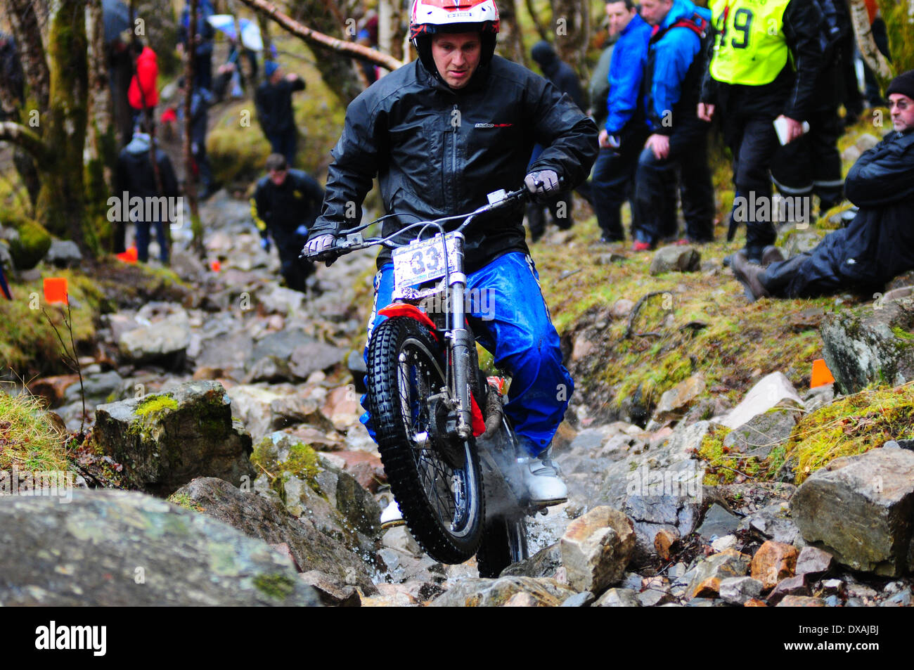 A man pulling a wheelie on a trials bike during a competition Stock ...