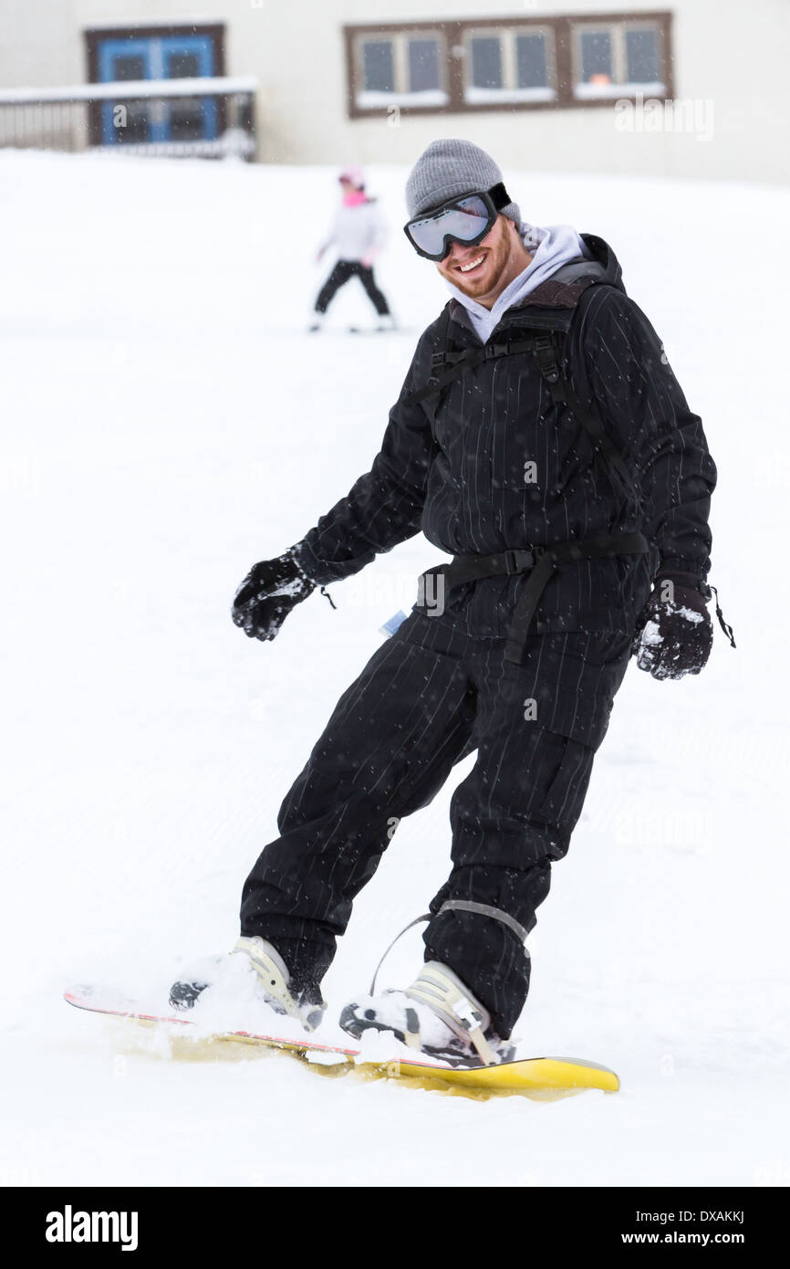 adult male snowboarding in the mountains of northern Idaho in snowy ...