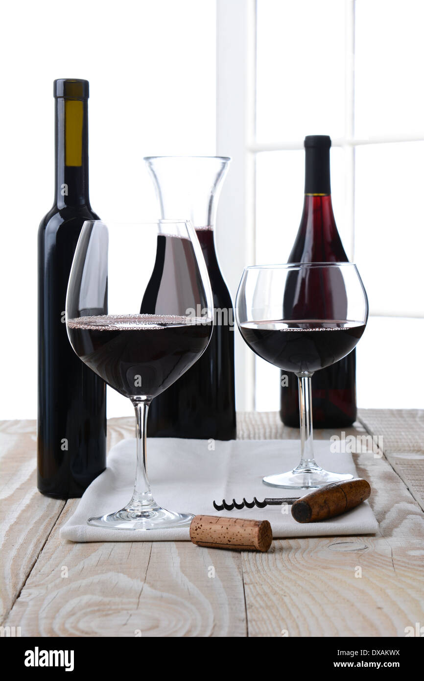 High key wine still life. Vertical format on a farmhouse style table ...