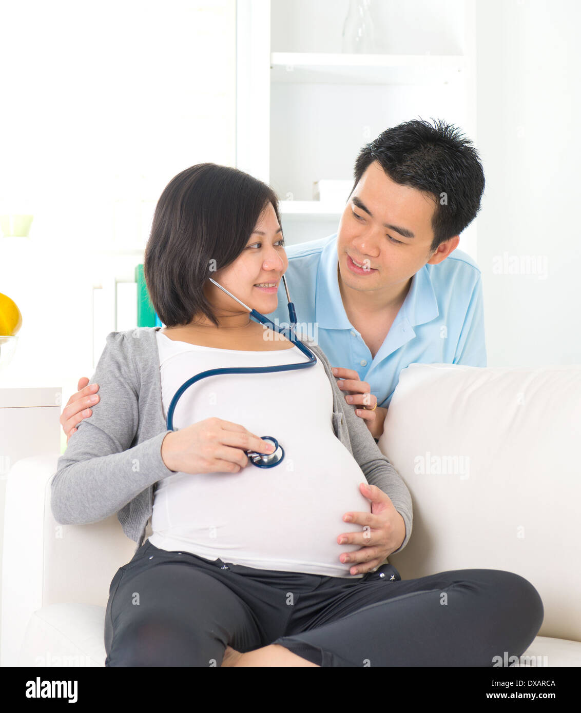 asian chinese pregnant couple lifestyle photo with living room and sofa ...
