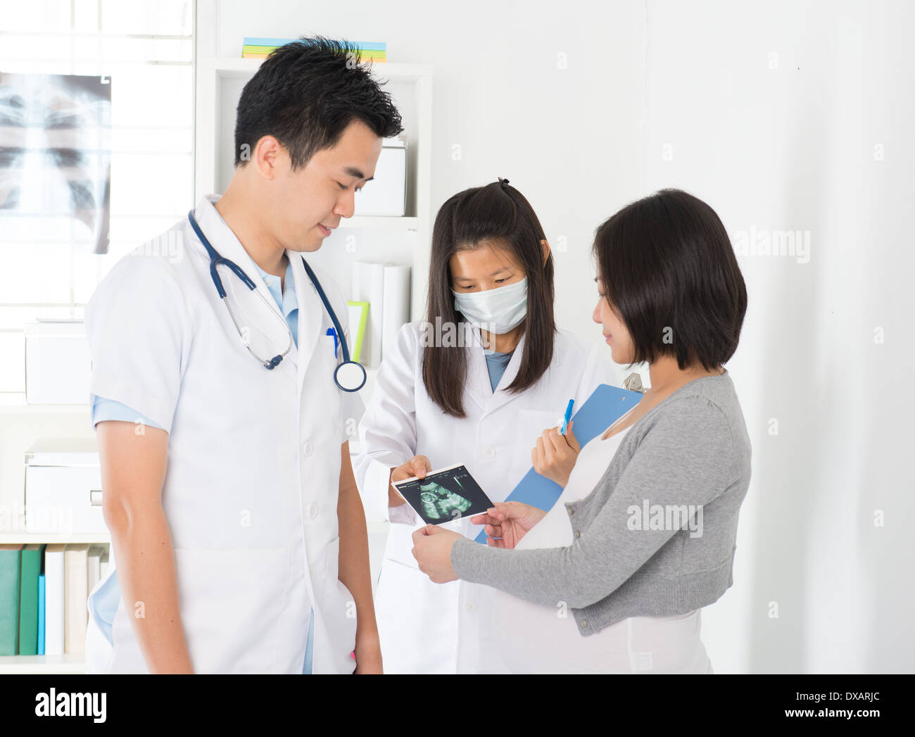 asian pregnancy check up with doctor and mother with ultrascan photo ...