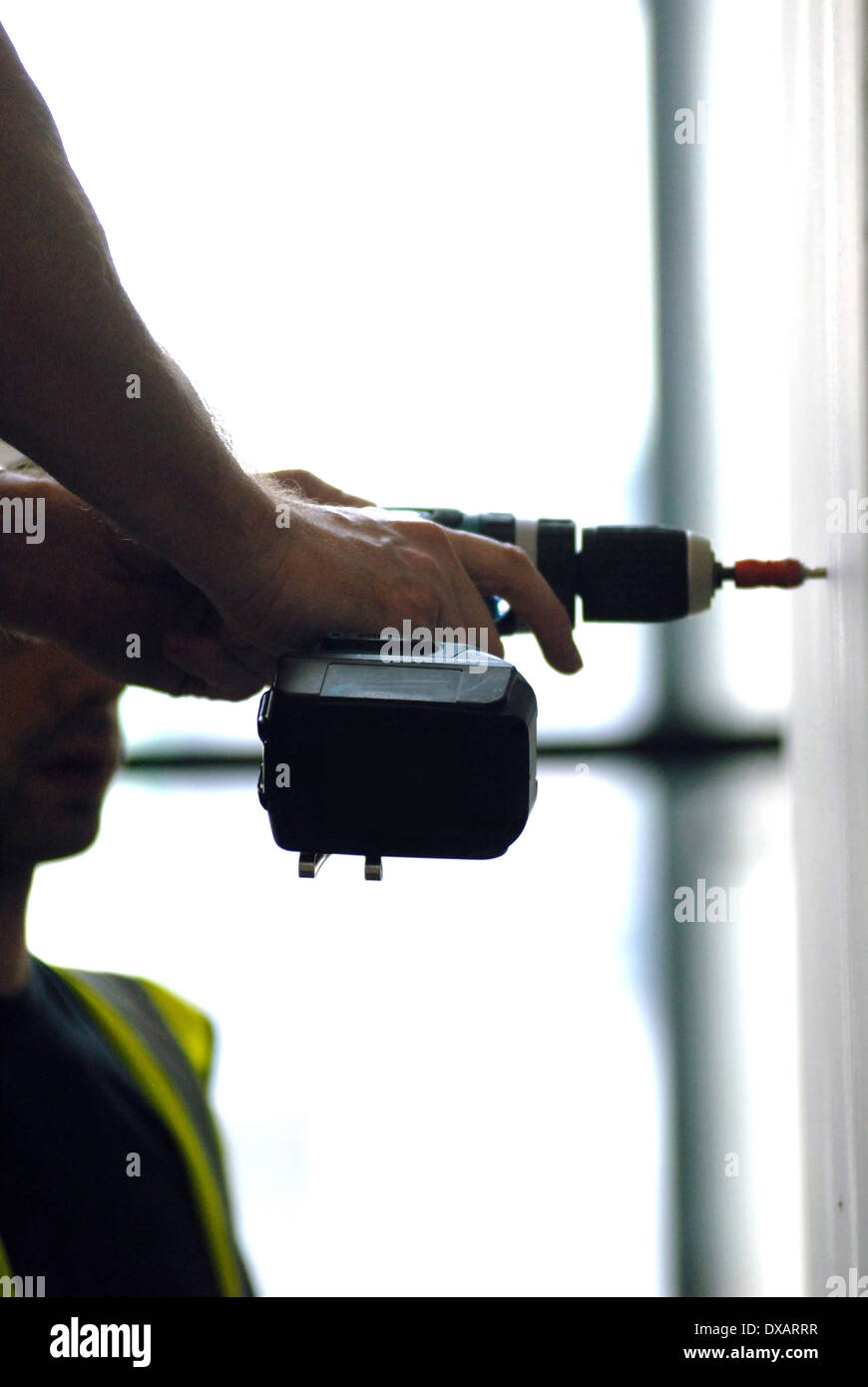 Workman using cordless drill Stock Photo - Alamy
