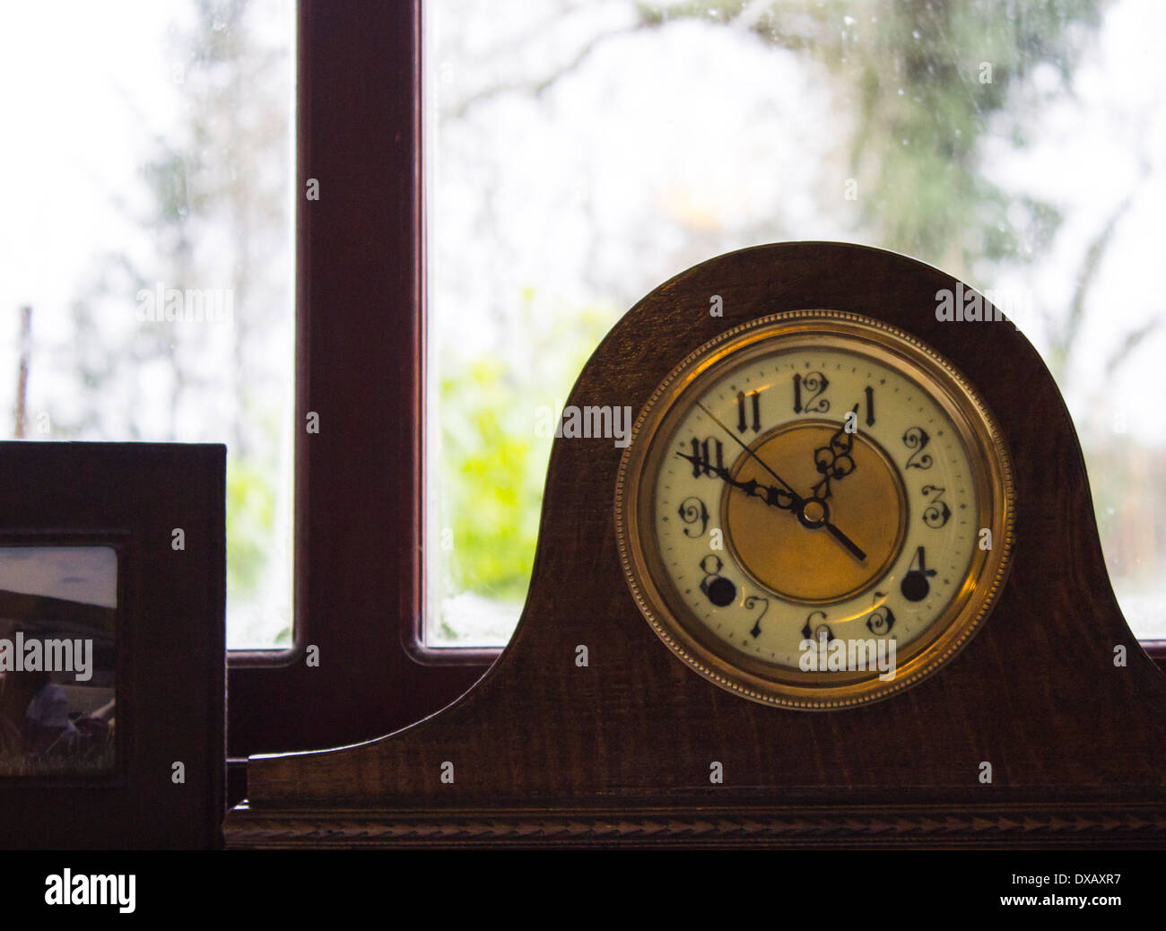 An old clock on a windowsill Stock Photo - Alamy