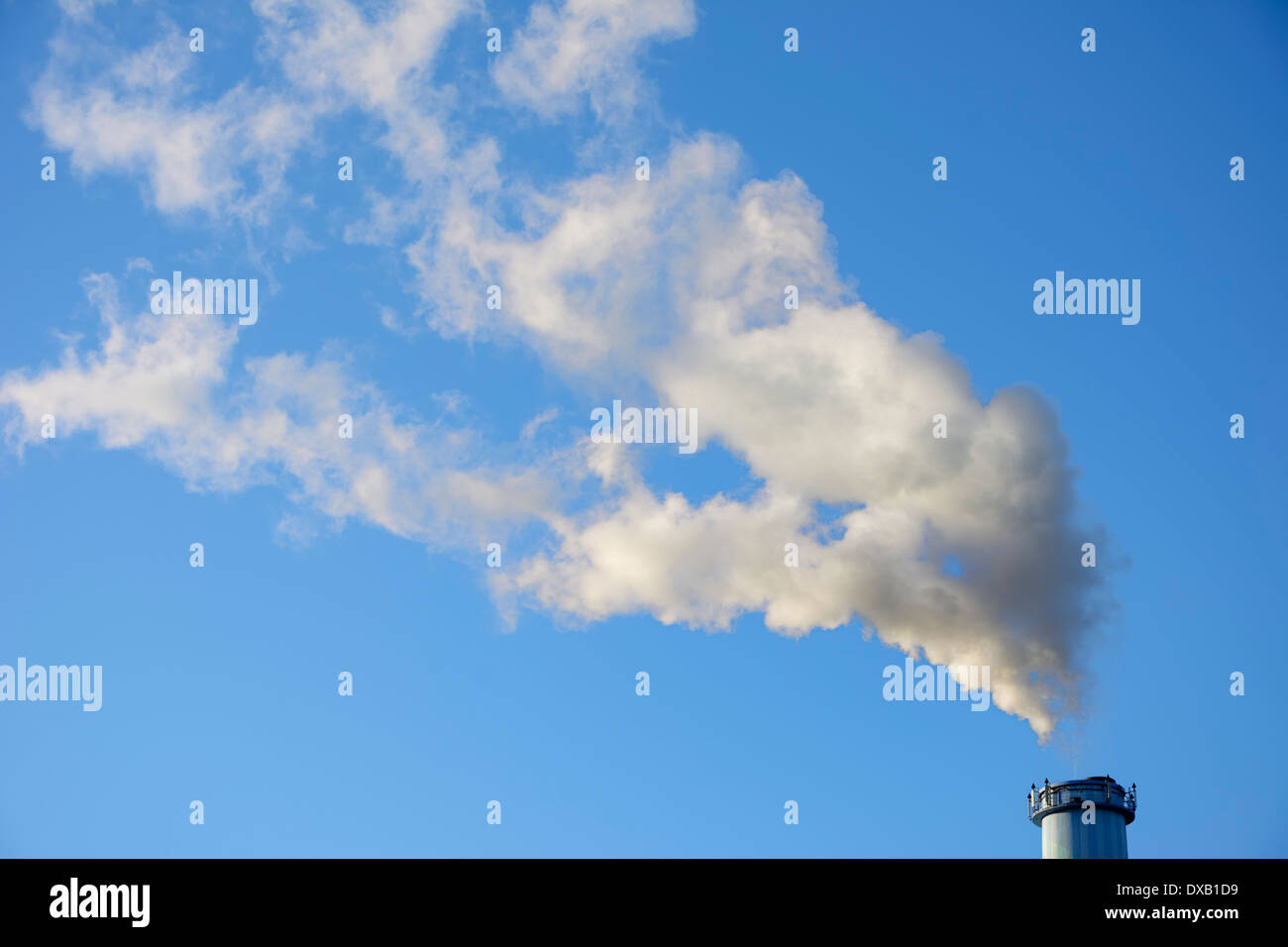Blue sky and smoke of a chimney Stock Photo - Alamy