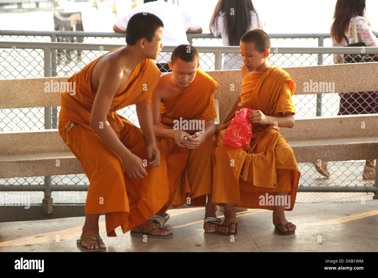 A group of Thai Buddhist monks using smart phone during waiting for ...
