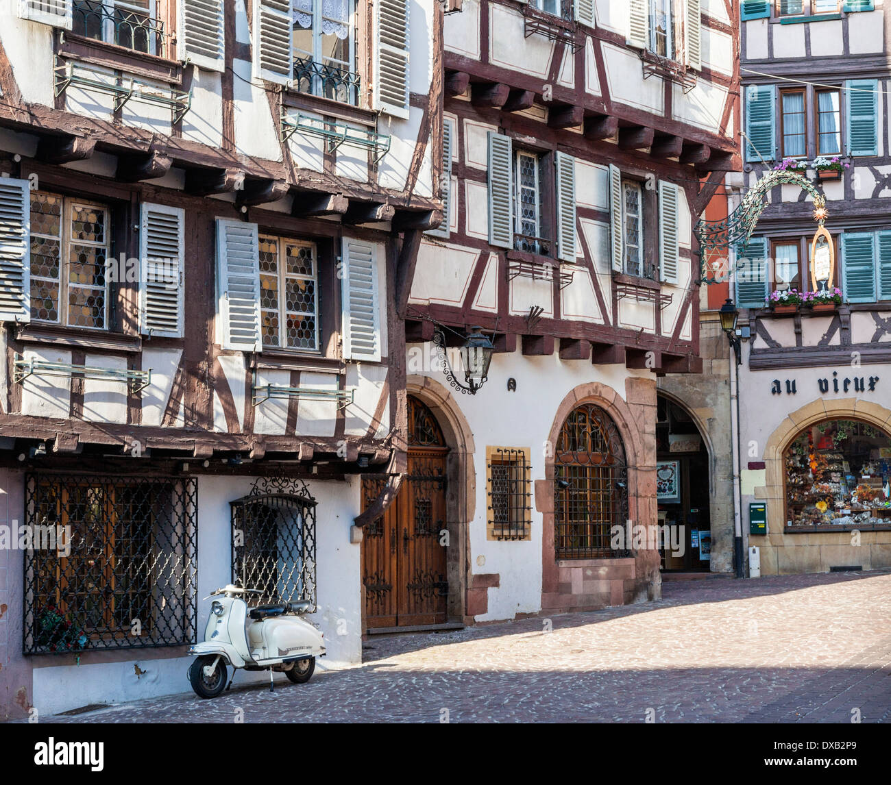 Vespa moped and half-timbered buildings in the old town of Colmar ...