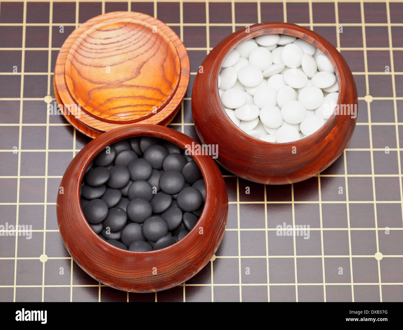 top view of black and white go game stones in wooden bowls Stock Photo ...