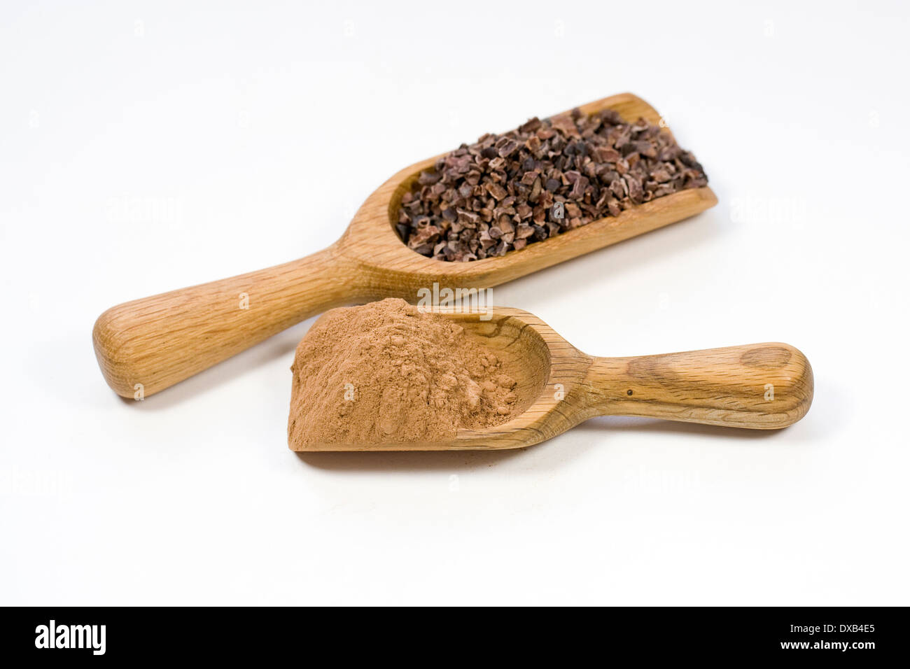 Scoop of raw cocoa nibs and a scoop of raw cacao powder Stock Photo - Alamy