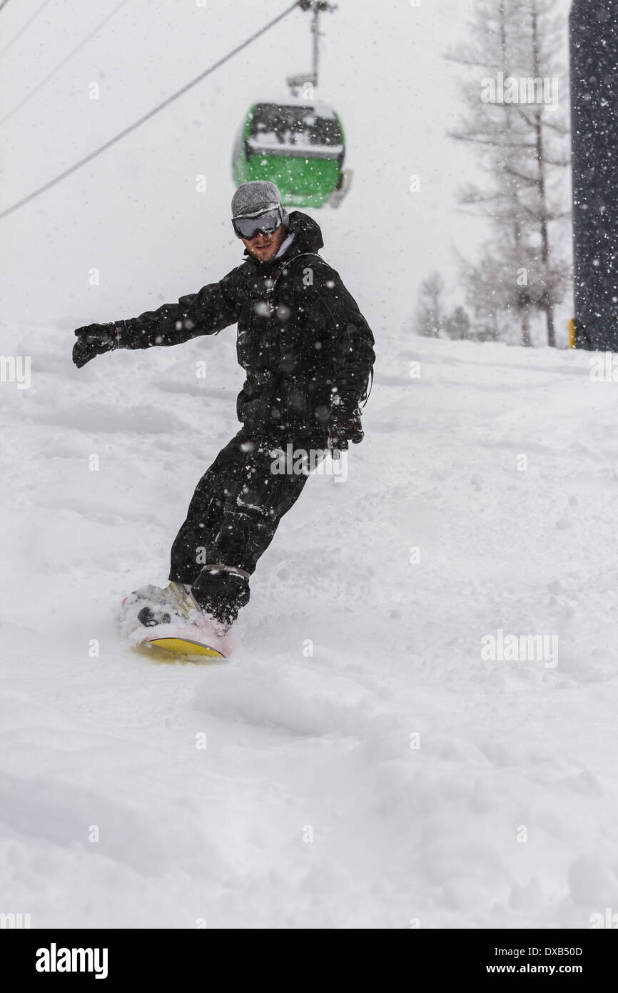 adult male snowboarding in the mountains of northern Idaho in snowy ...