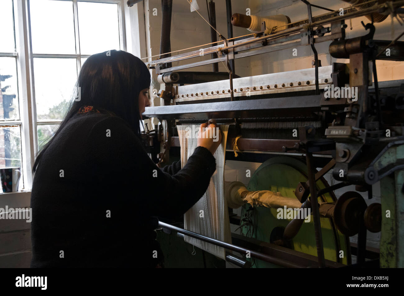 Young woman demonstrating a framework knitting machine at the Framework ...