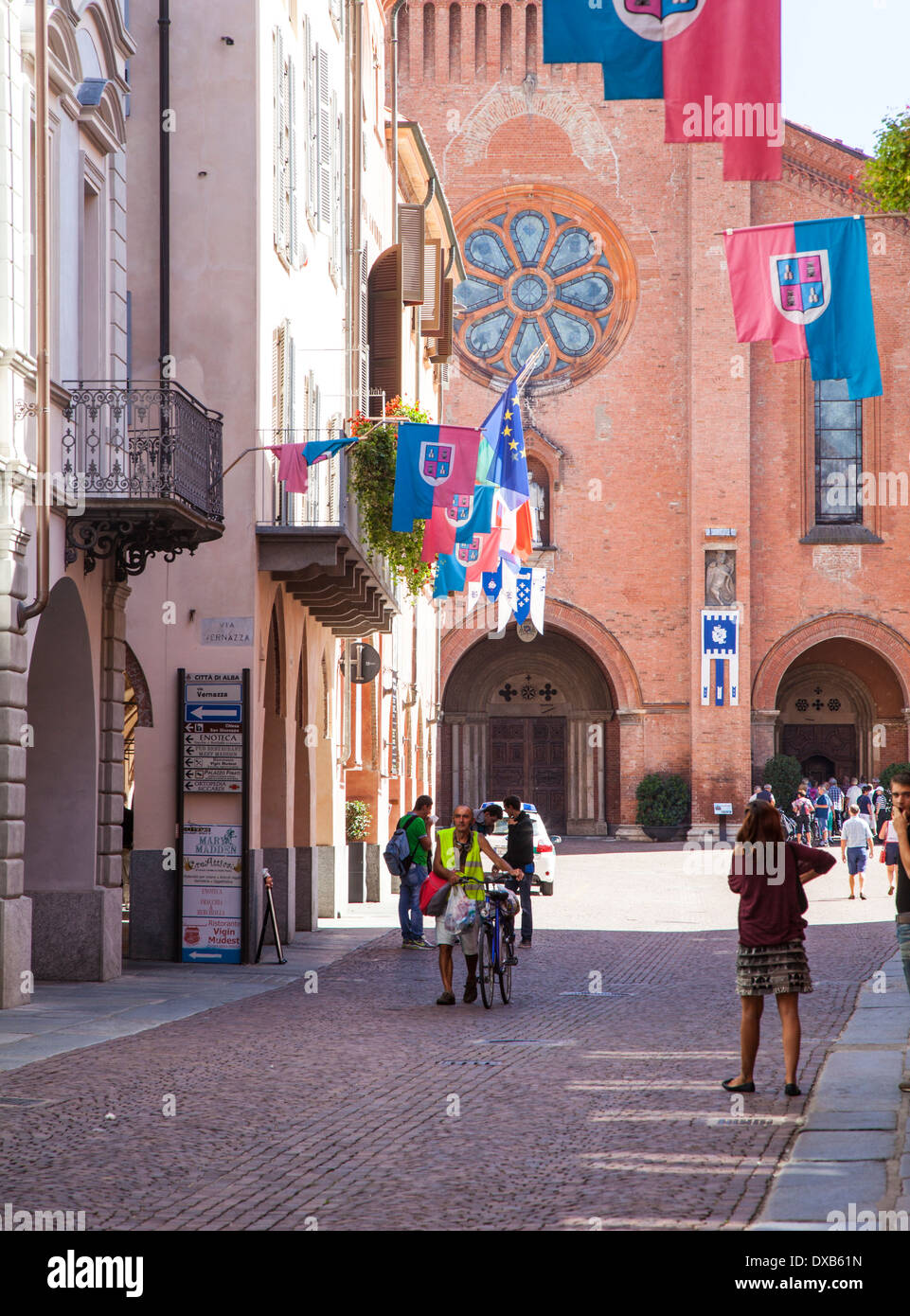 Church, buildings and colourful flags on display in Alba, Piemonte ...