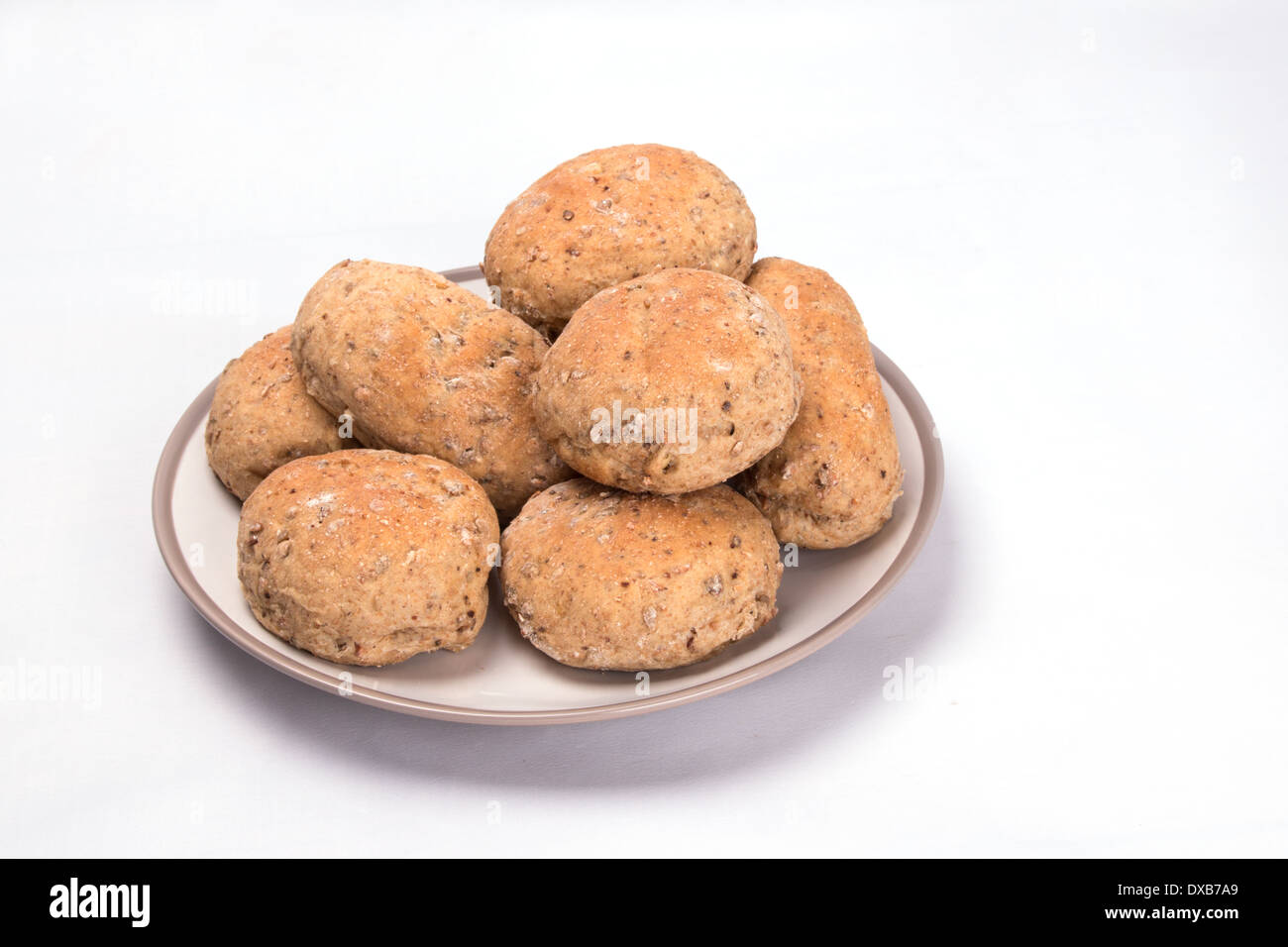 A stack/ pile/ heap/group of Granary/wholemeal/brown seeded bread buns ...