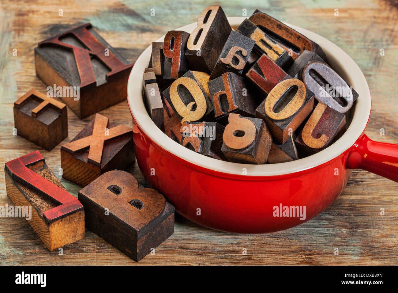 typography concept - a pot of letterpress wood type printing blocks ...