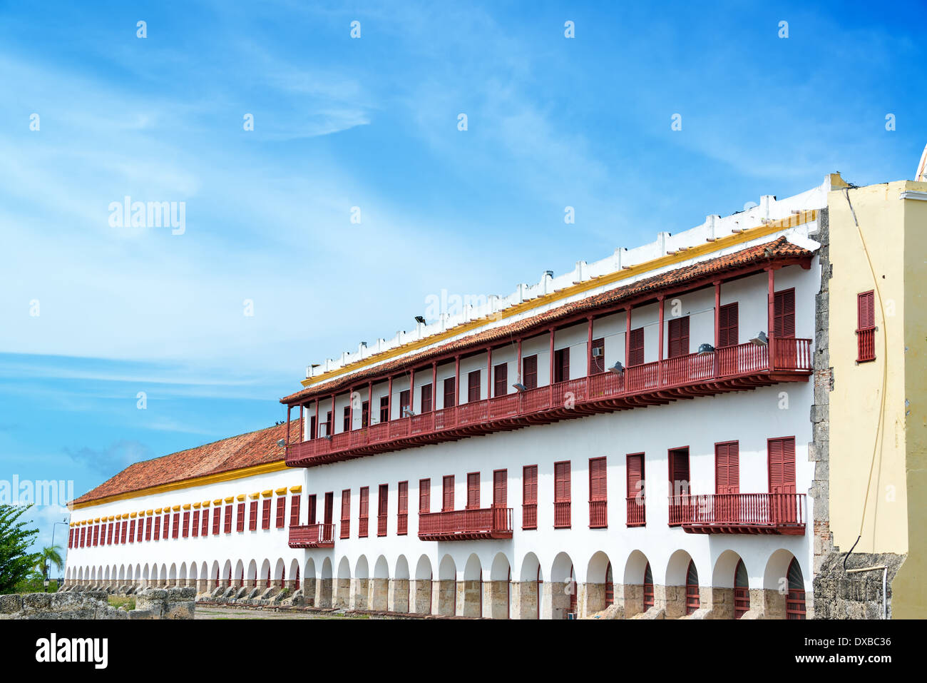Facade of a white colonial buildings with red balconies in the historic ...
