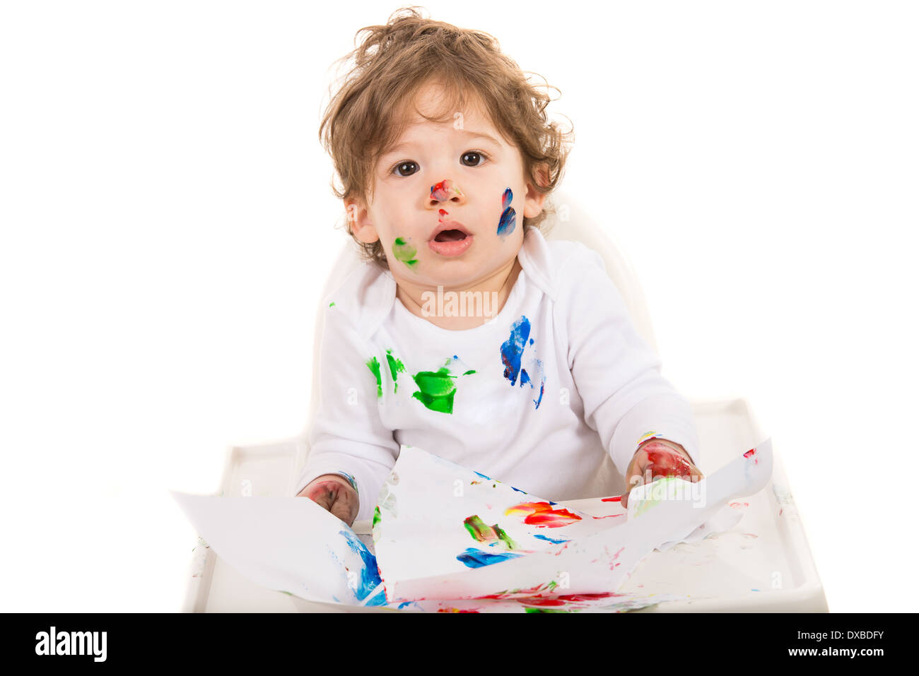 Amazed toddler boy with colorful paints on face isolated on white ...