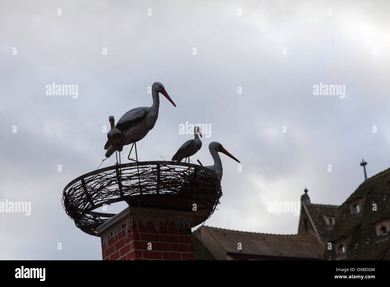 Storks as decorations on the chimney of a Christmas market chalet ...