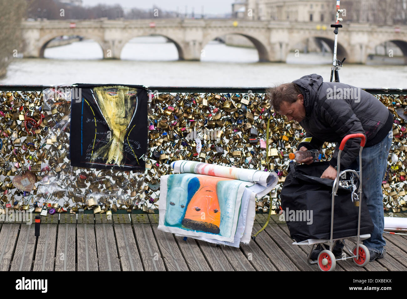 Man Selling Art with Love padlocks adorn one of Paris Famous Bridges ...