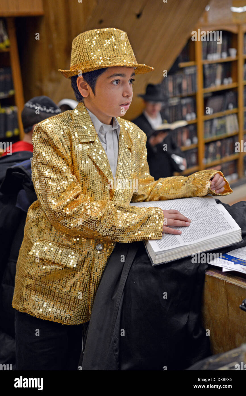 A religious Jewish young boy wearing a costume with a yellow glittery ...