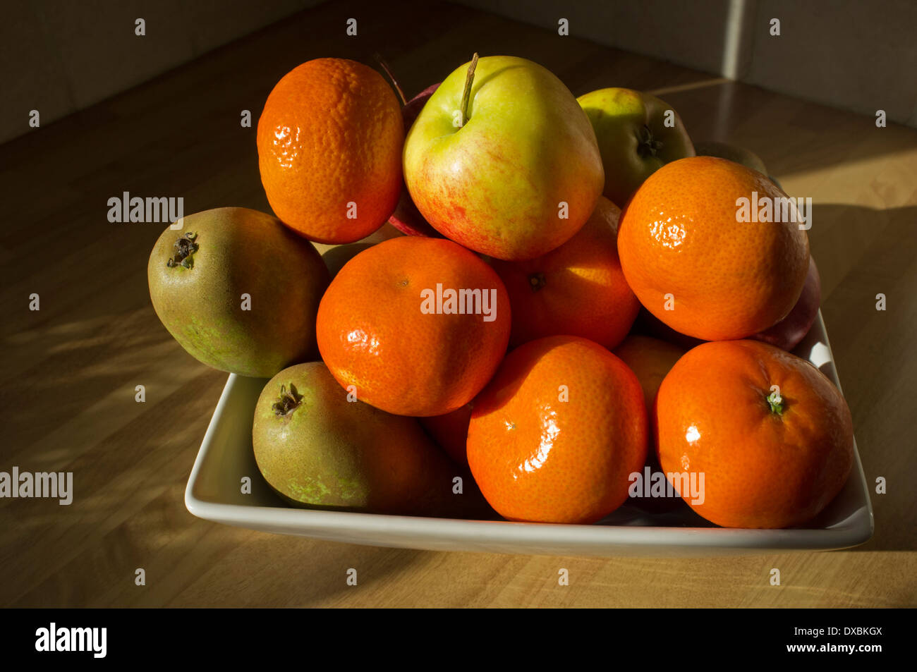 Bowl of fruit in sunshine Stock Photo - Alamy