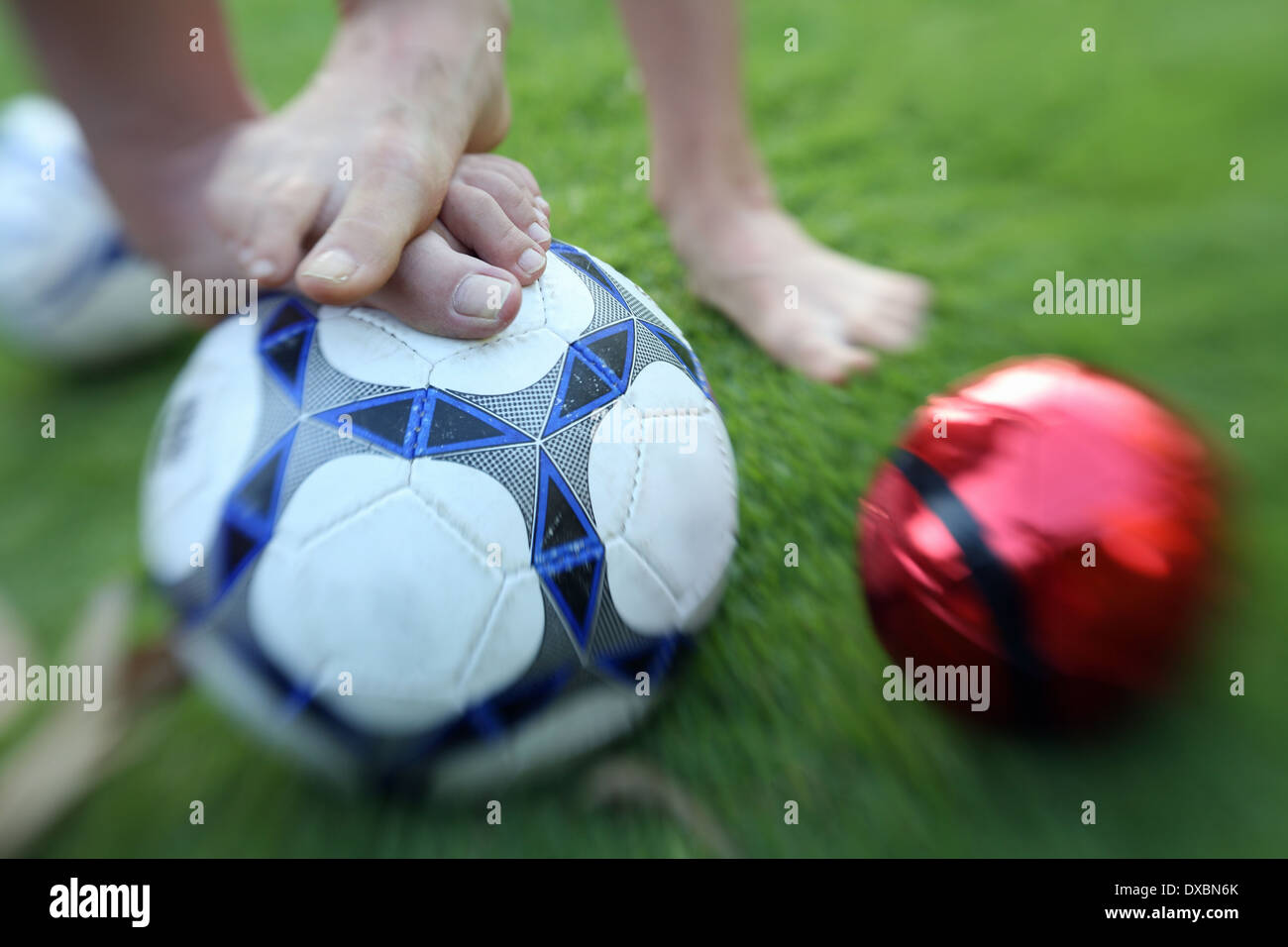 Two children's feet with balls Stock Photo - Alamy