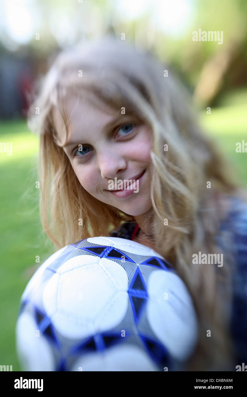 Girl posing with ball Stock Photo - Alamy