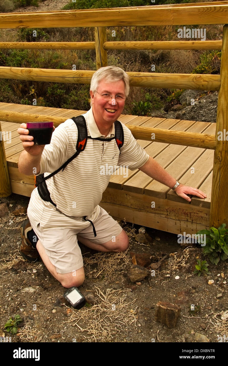 A happy geocacher finds his 100th geocache Stock Photo - Alamy