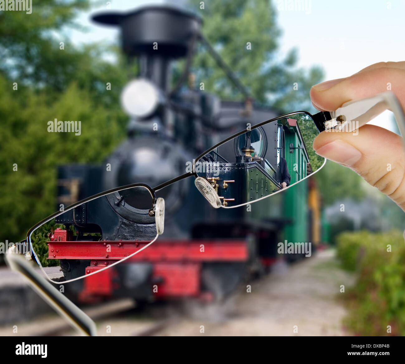Man is viewing to vintage train on display through eyeglasses Stock ...