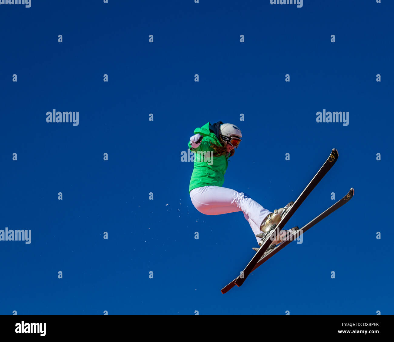 Female skier flying through the air Stock Photo - Alamy