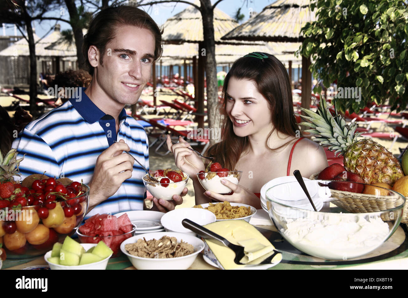 Young adult couple eating breakfast Stock Photo - Alamy