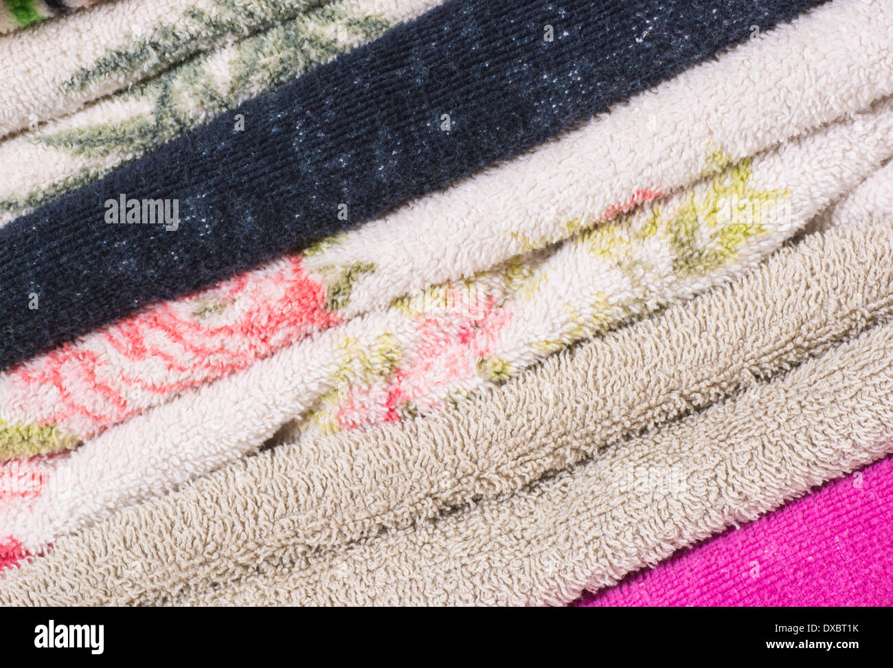 stack of worn towels of various colours and patterns Stock Photo - Alamy