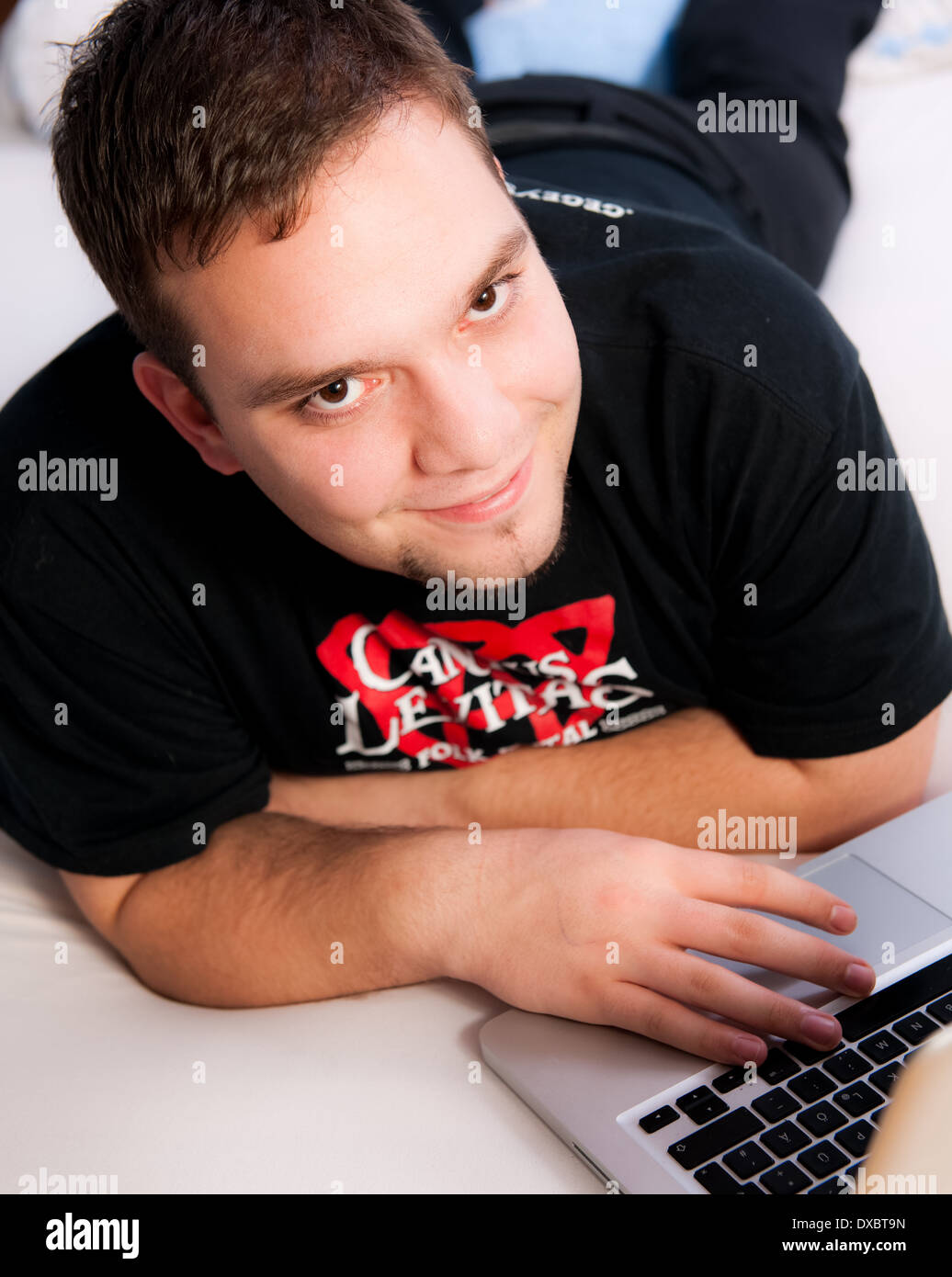 young man in bed with laptop browsing the internet Stock Photo - Alamy