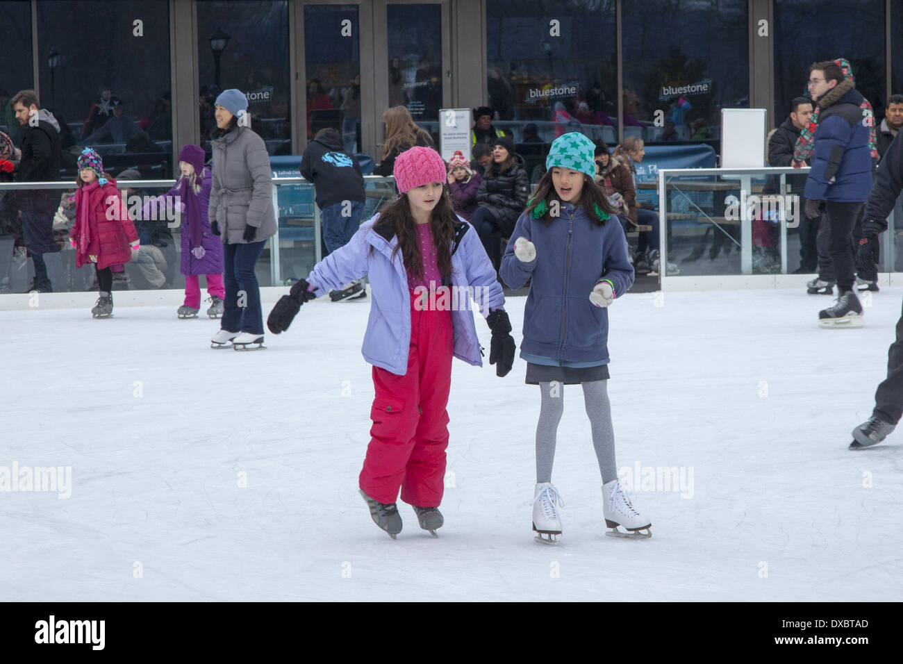 Two young friends skate together in Prospect Park, Brooklyn, NY Stock ...