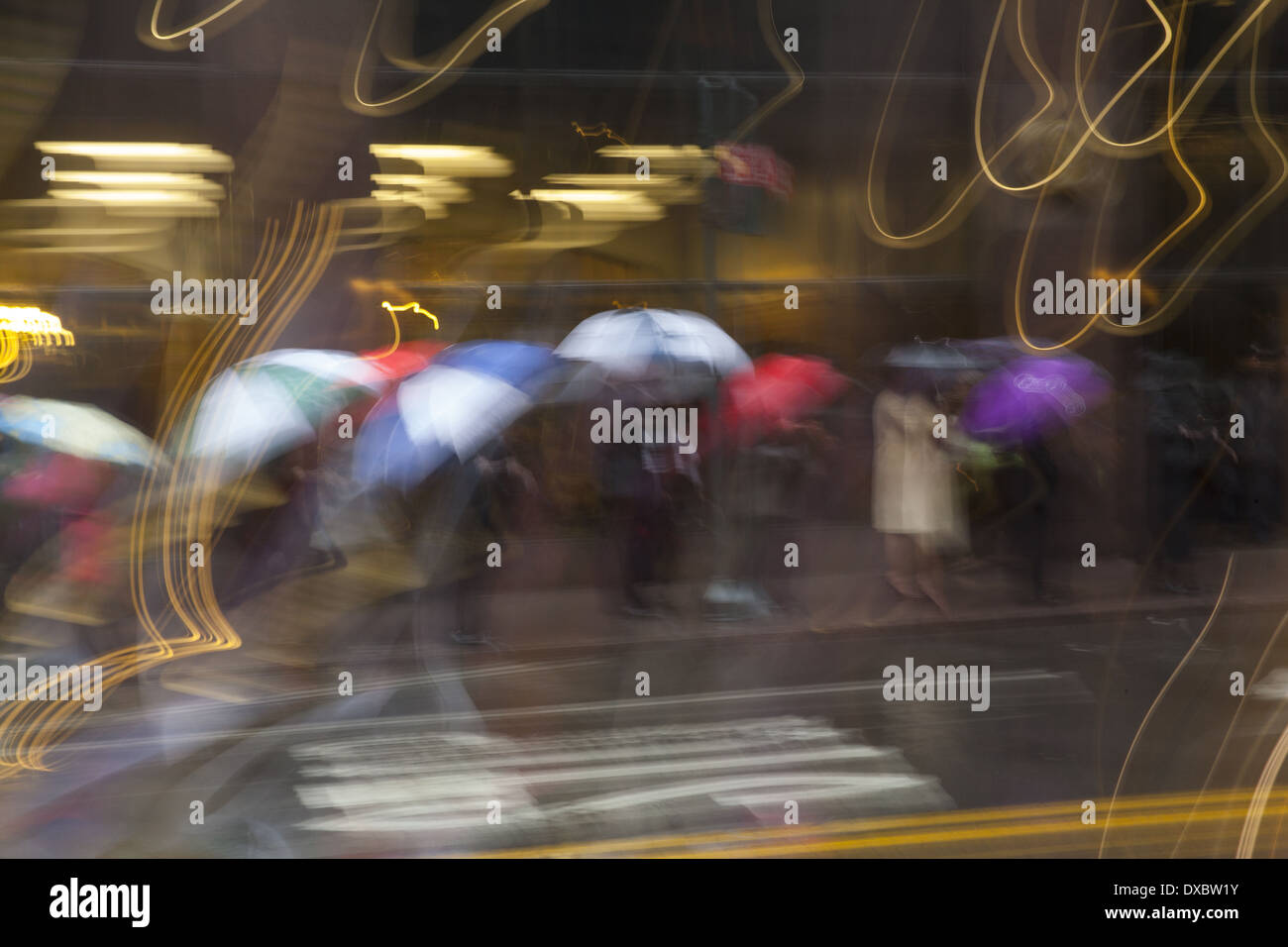 People wait for a public bus outside Grand Central Station on a rainy ...