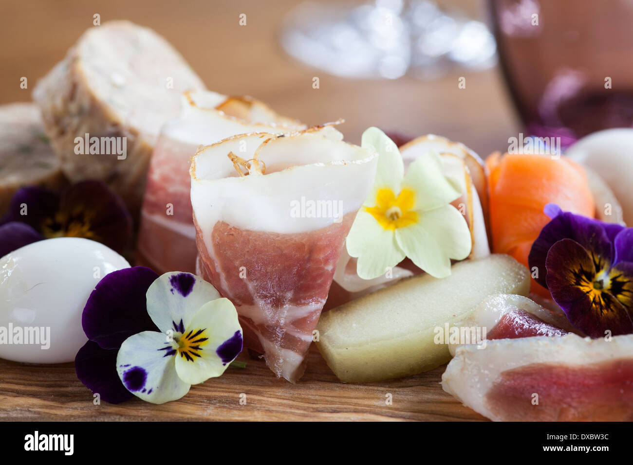 Meat platter decorated with flowers Stock Photo - Alamy