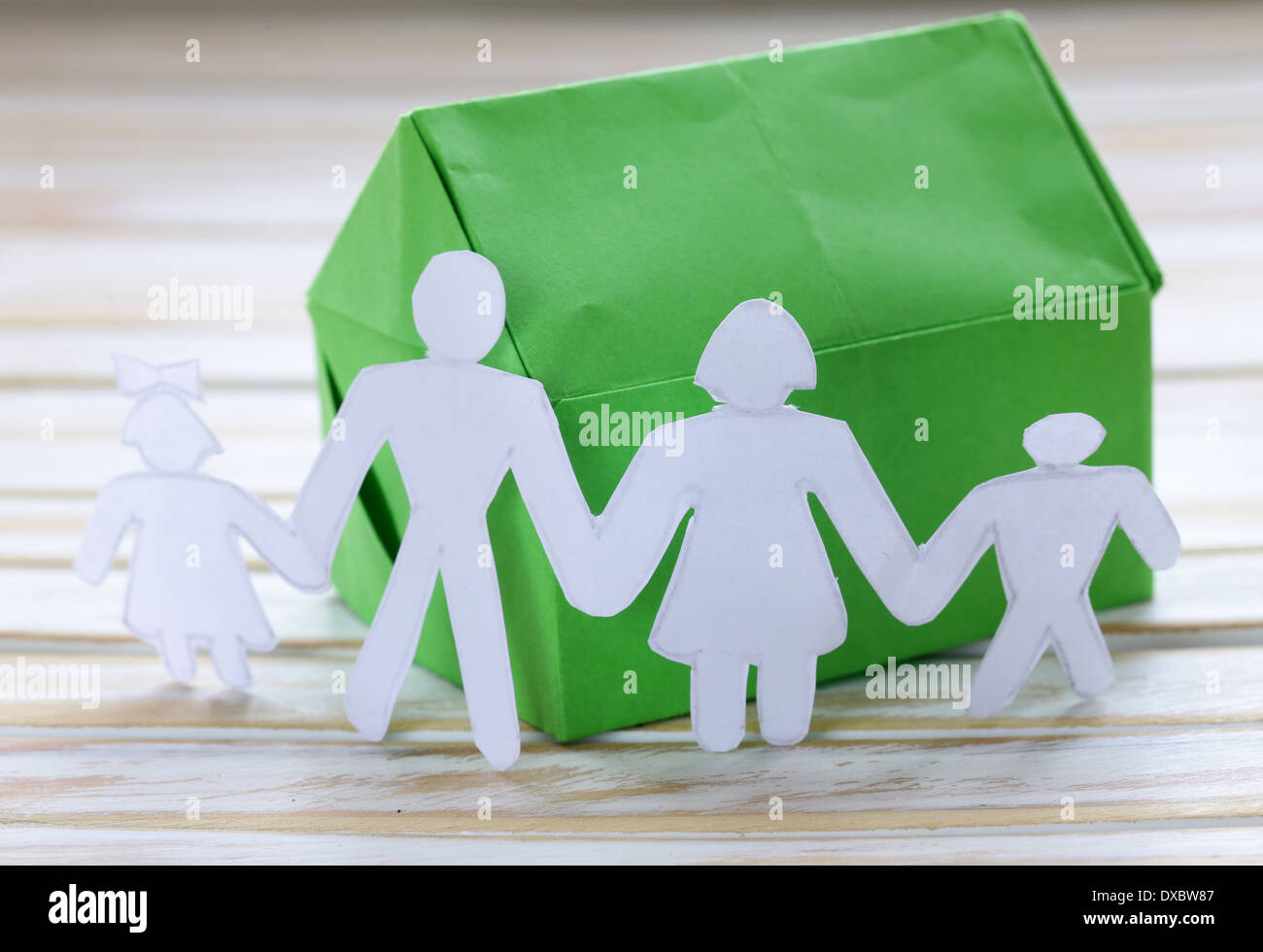colorful origami paper house with human family Stock Photo - Alamy