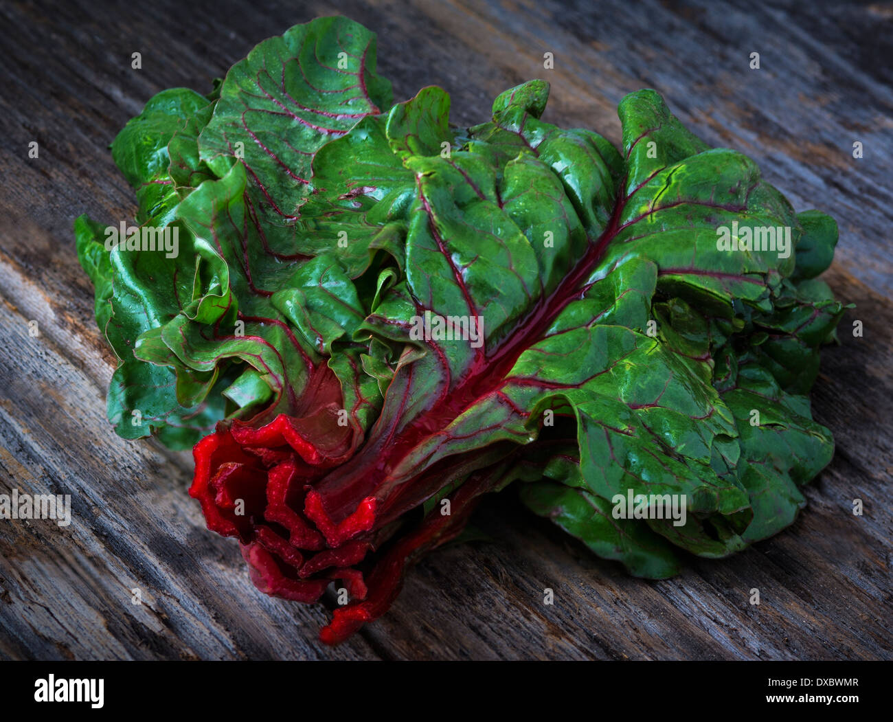 Organic red ruby swiss chard raw on rustic wood Stock Photo - Alamy
