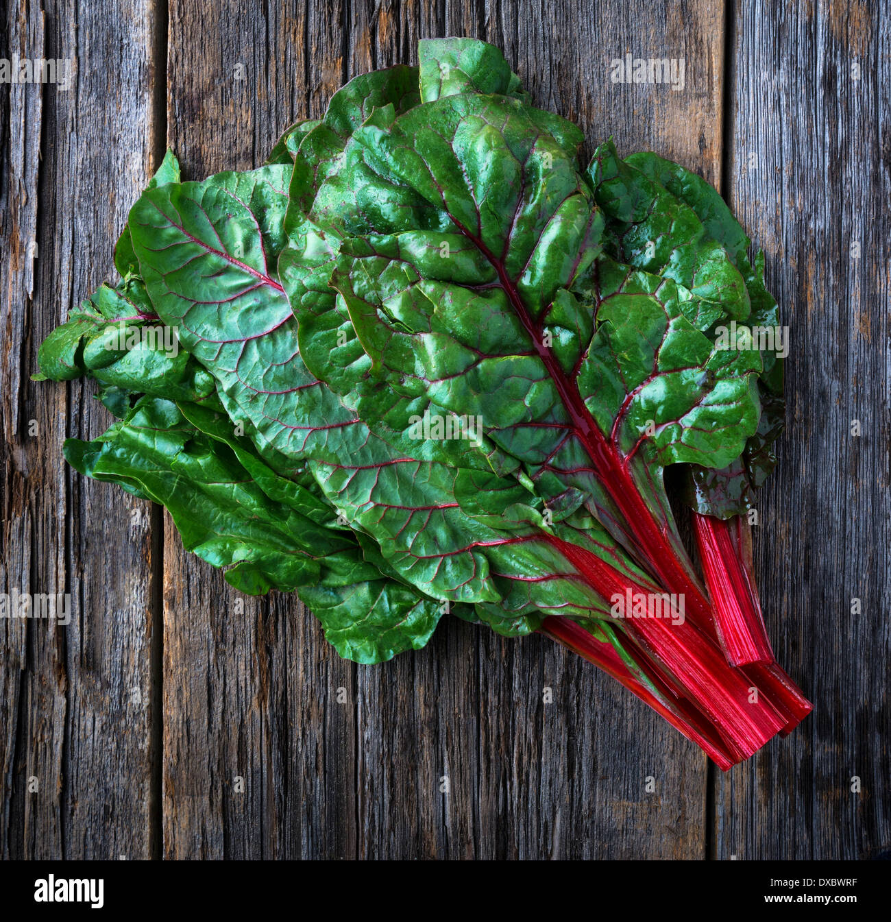 Organic red ruby swiss chard raw on rustic wood Stock Photo - Alamy