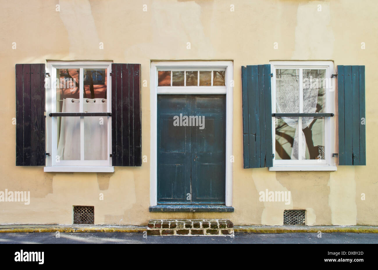 An old Colonial-era house entrance with windows and shutters built in ...