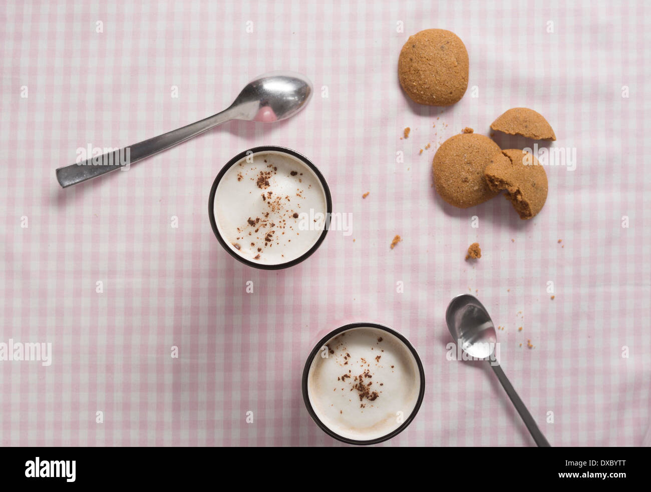 Cappuccino in pink cup with cocoa and almond milk foam and ginger ...