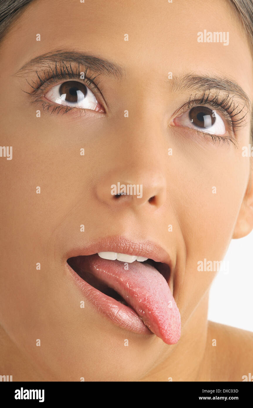 Female young adult face, tongue out Stock Photo - Alamy