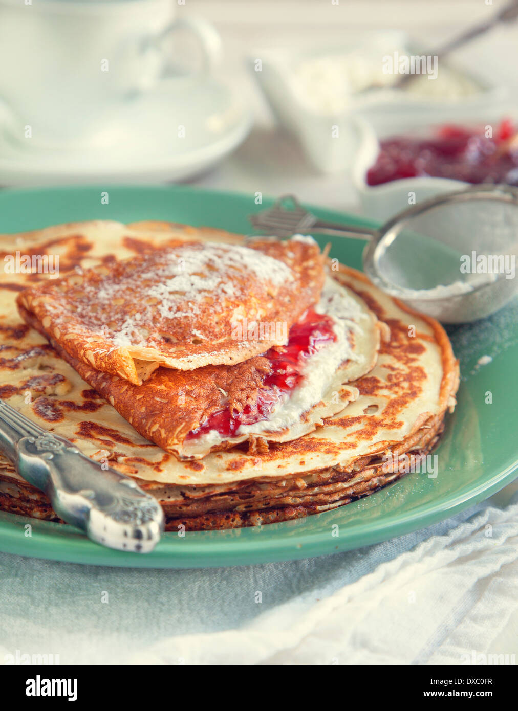 Crepes with cream cheese and strawberry jam. Toned image Stock Photo ...