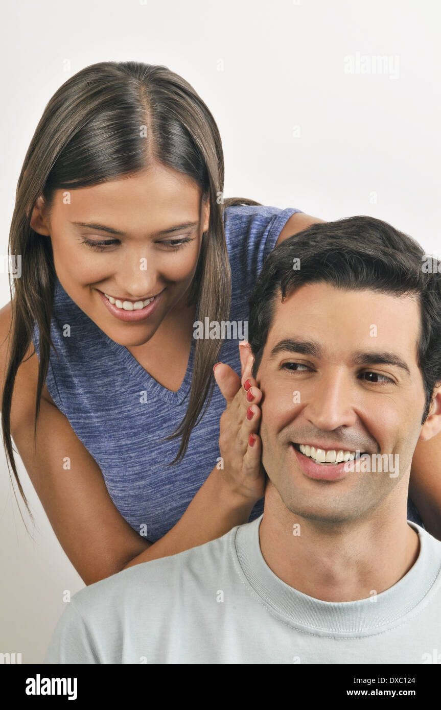 Female young adult touching man's cheek Stock Photo - Alamy